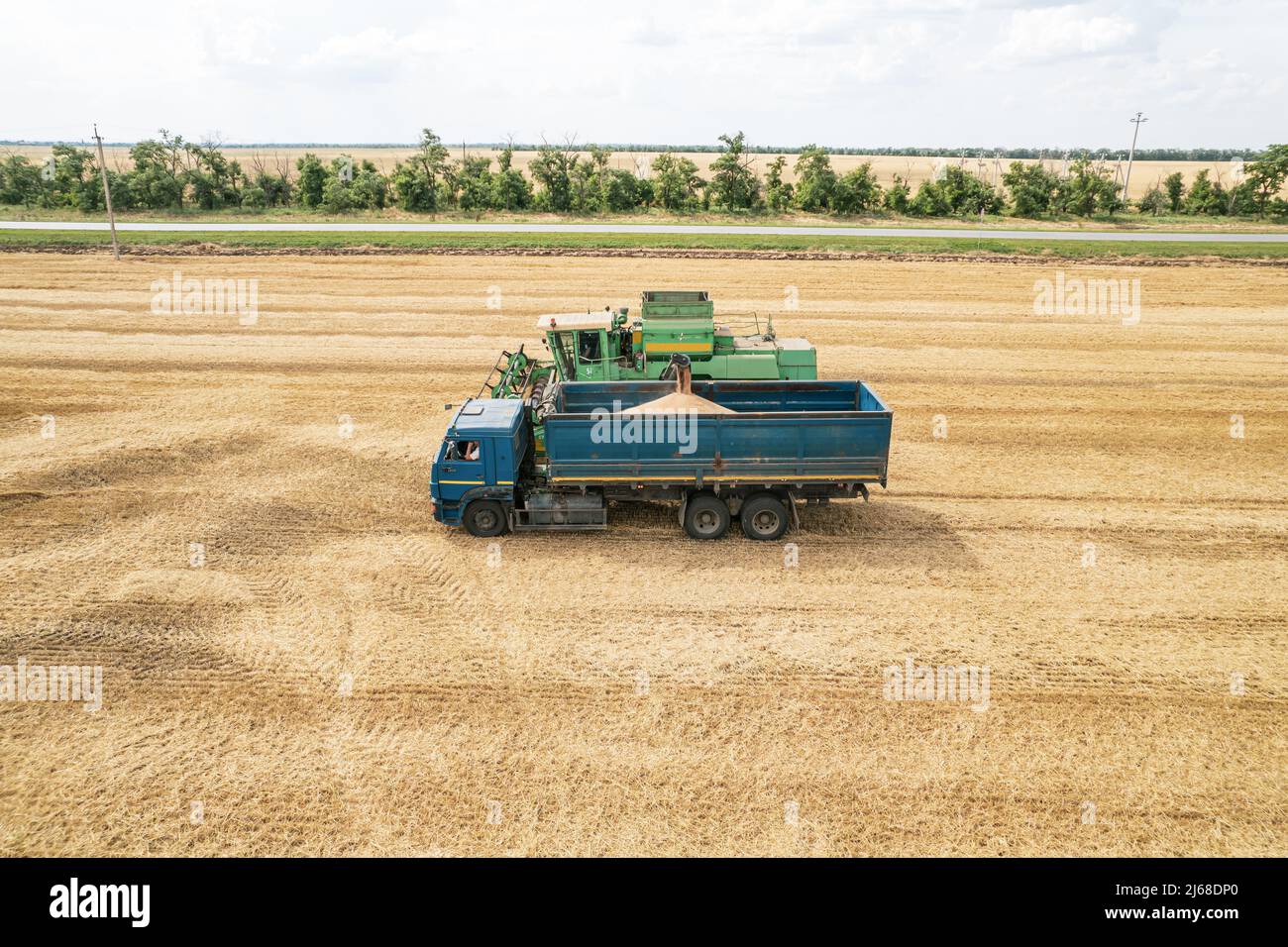 Combine harvesting: aerial view of agricultural machine collecting ...