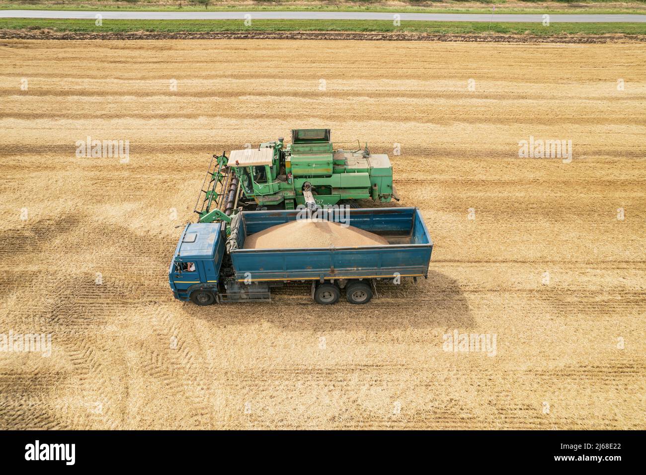 Combine harvesting: aerial view of agricultural machine collecting ...