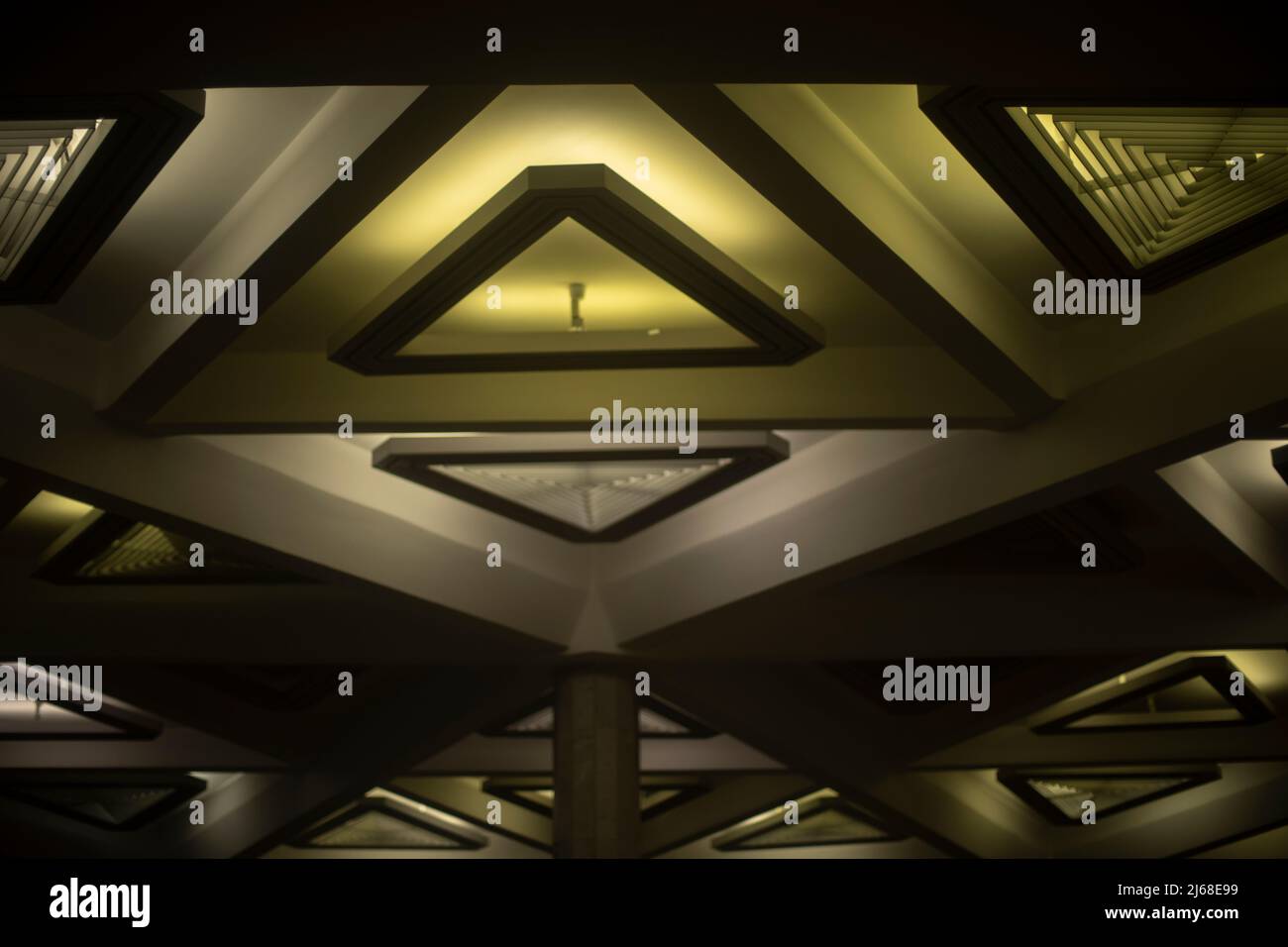 Light of lamps on ceiling. Architecture details. Triangles in building ...