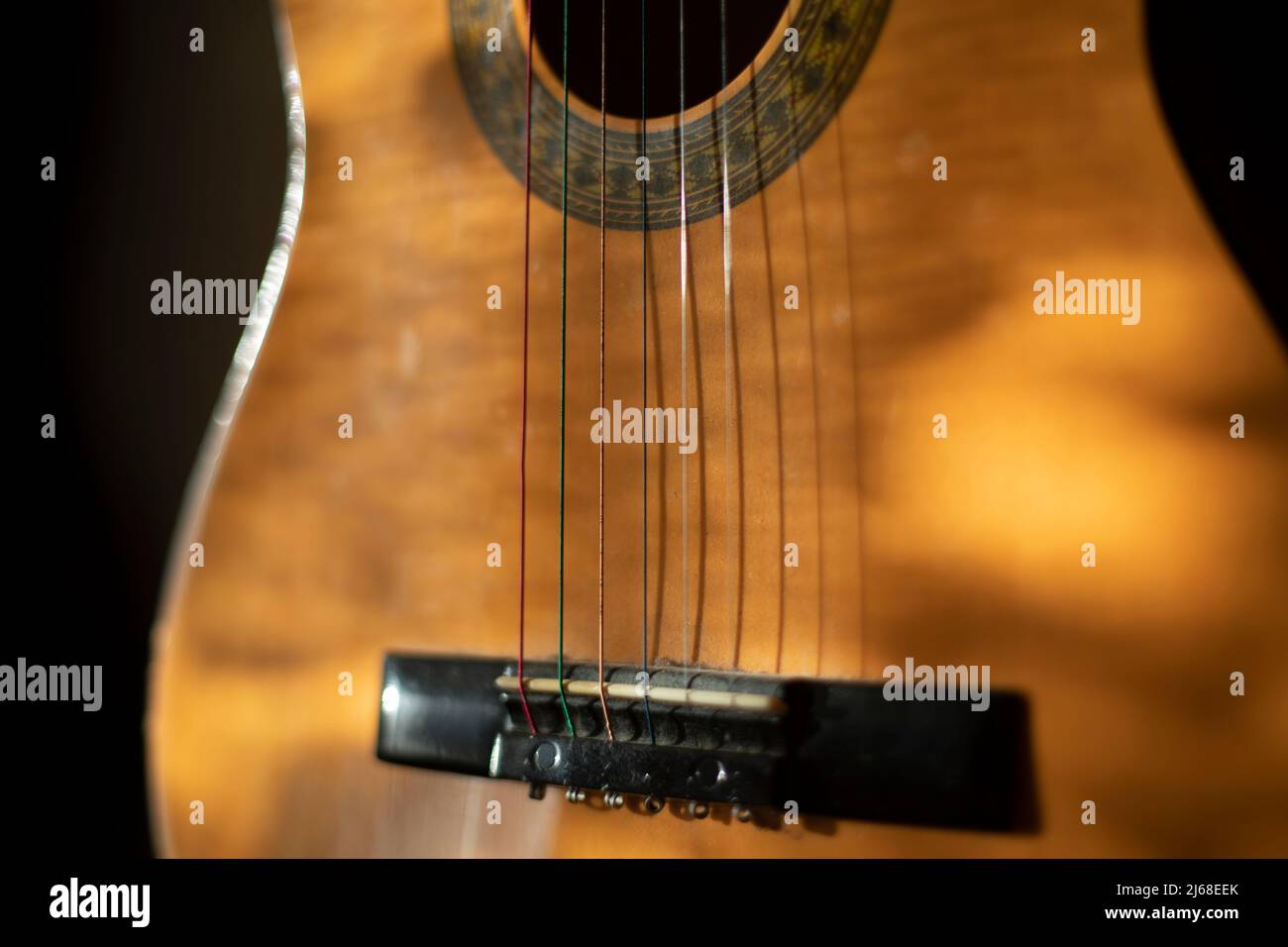Classical guitar in light of sun. Strings on guitar. Details of ...
