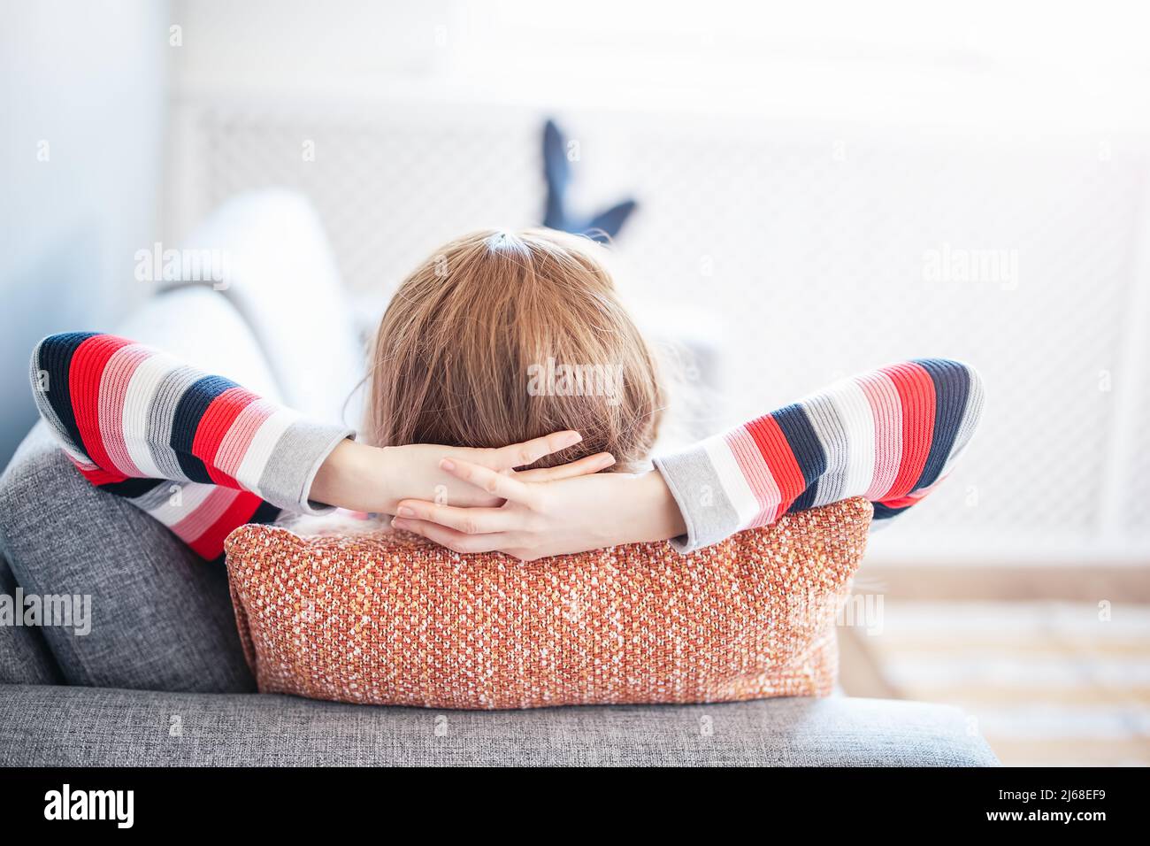 Tired woman lying down on the couch after workday Stock Photo - Alamy