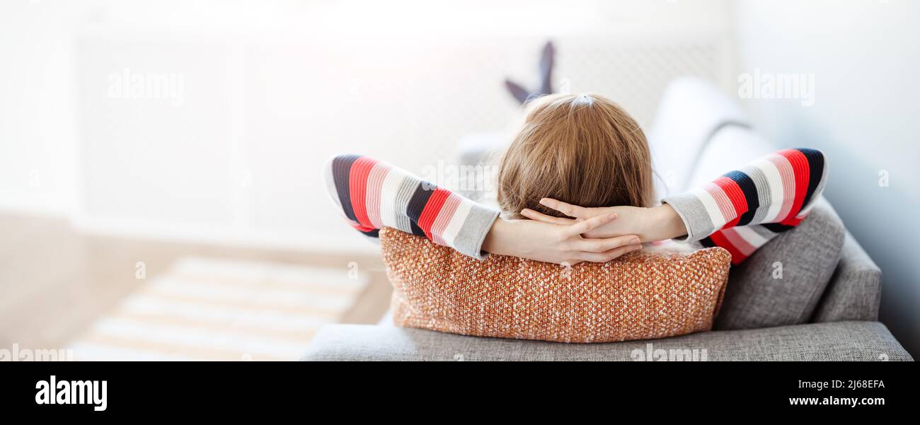 Tired woman lying down on the couch after workday Stock Photo - Alamy