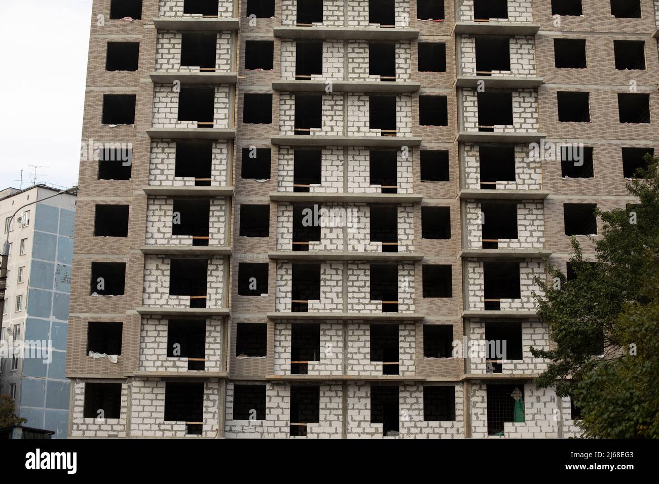 Building is windowless. House under construction. Wall covering ...