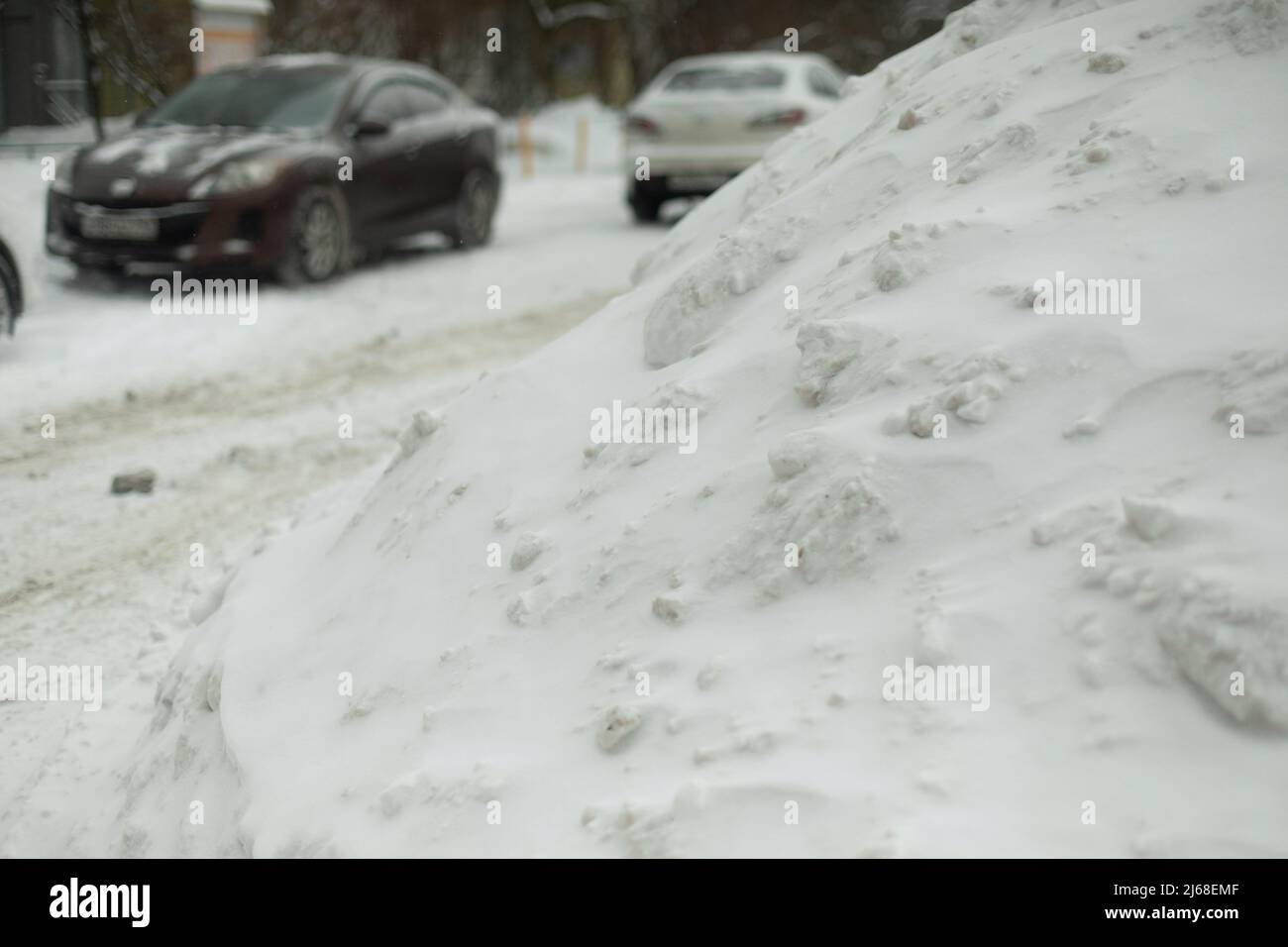 Snow in parking lot. Snowdrift on road. After snowstorm. Slide of ice ...