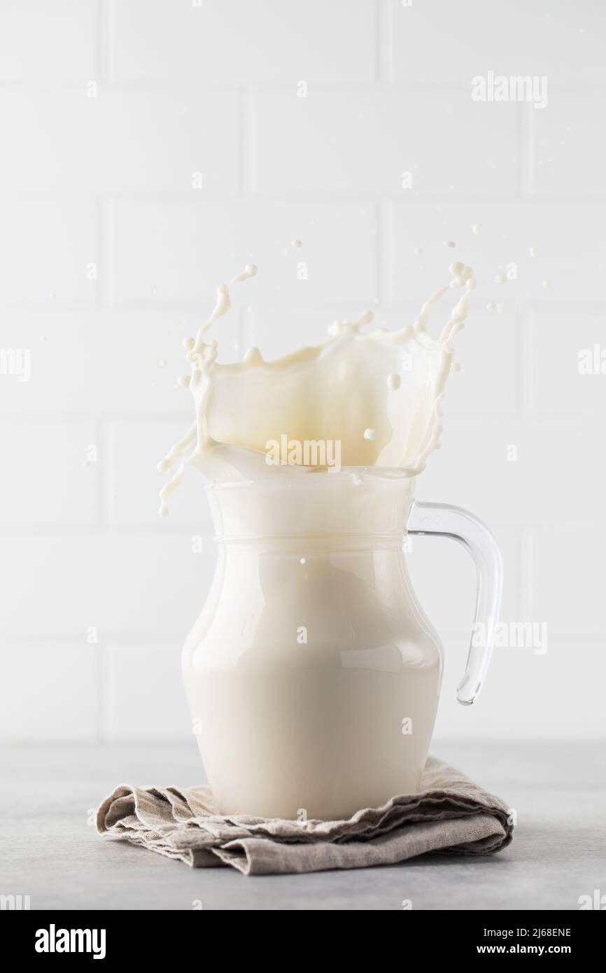 Splash and splash in a jug of vegetable milk. The concept of a healthy ...