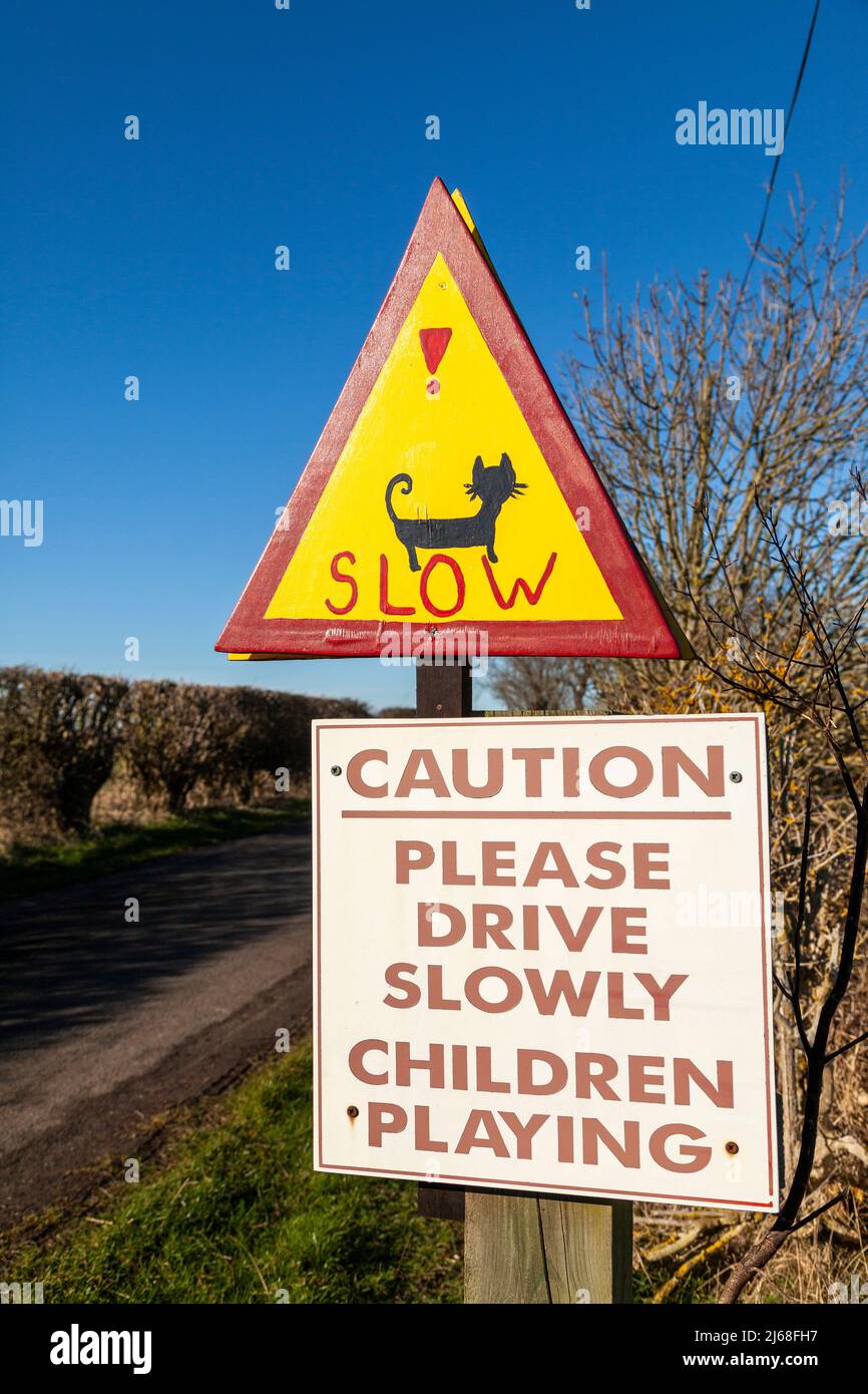 A home made sign warning motorists about cats crossing Stock Photo - Alamy