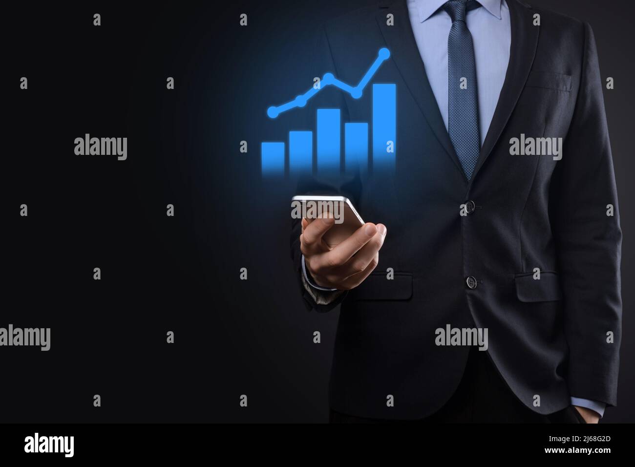 Businessman holding tablet and showing a growing virtual hologram of ...