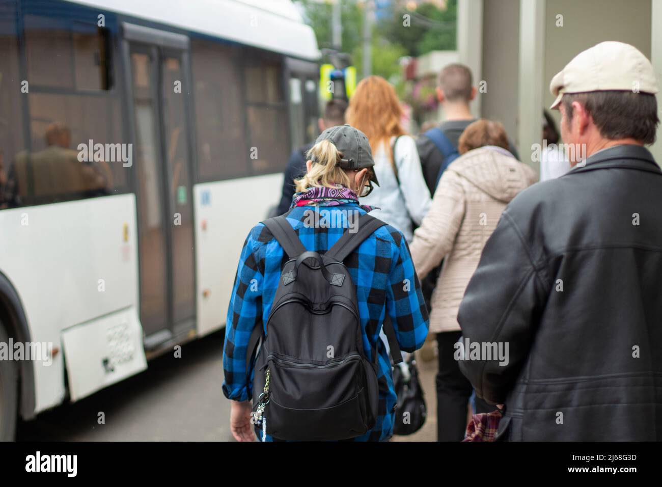 The girl goes to the bus. A woman sits down on public transport. The ...
