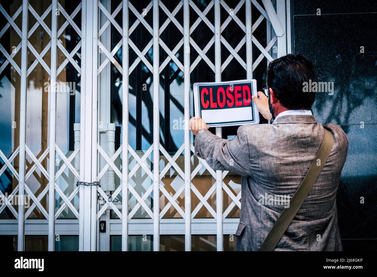Businesswoman closing her business activity due economy crisis putting ...