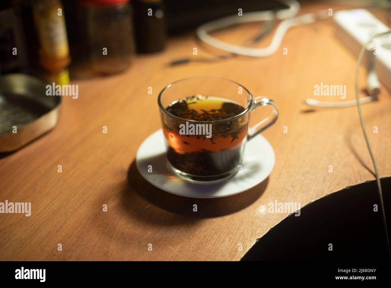 Tea in clear cup. Drink is hot. Tea leaves in boiling water. Tea party ...