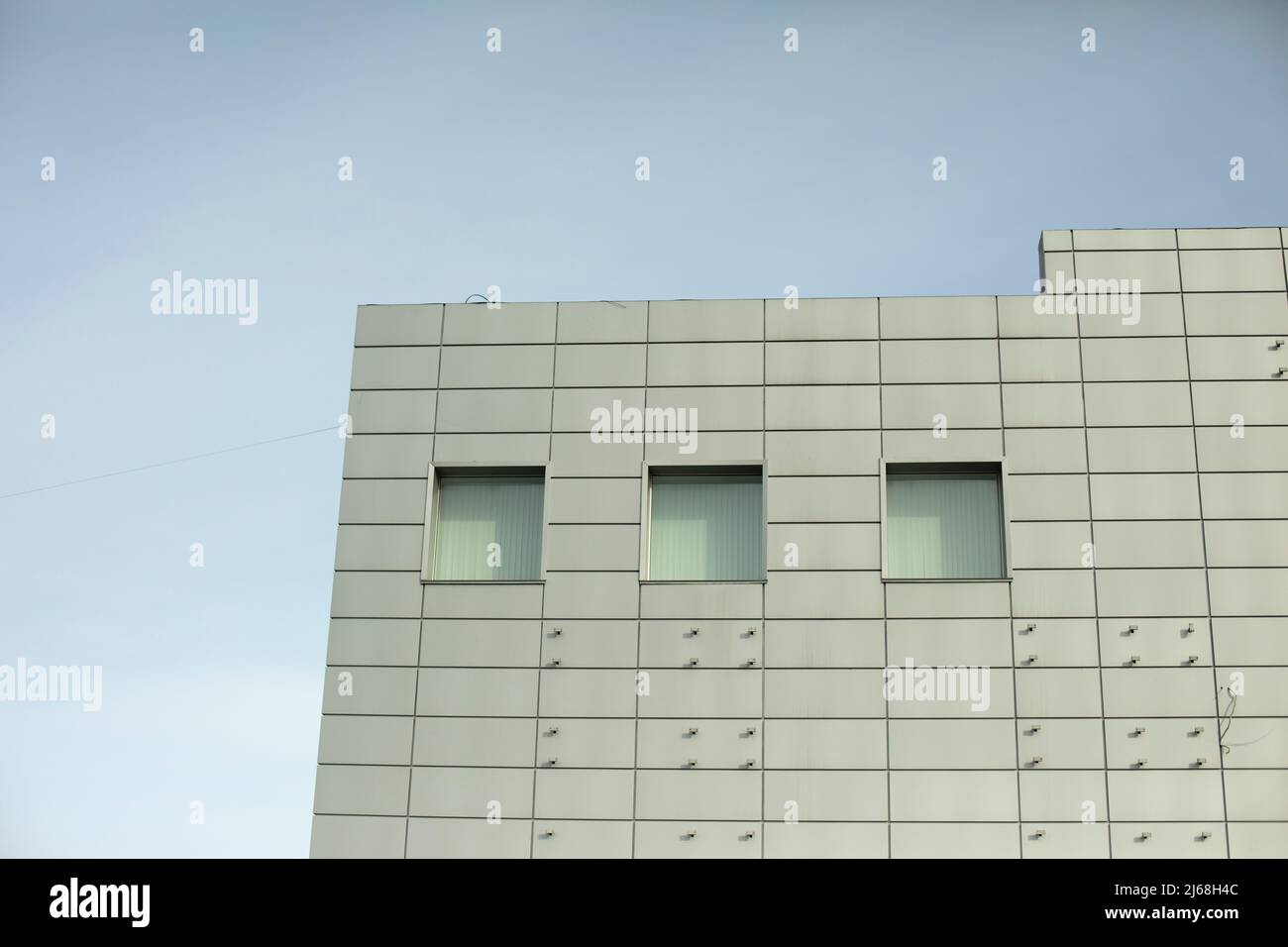 Modern building is gray in color. Facing panel on office building ...