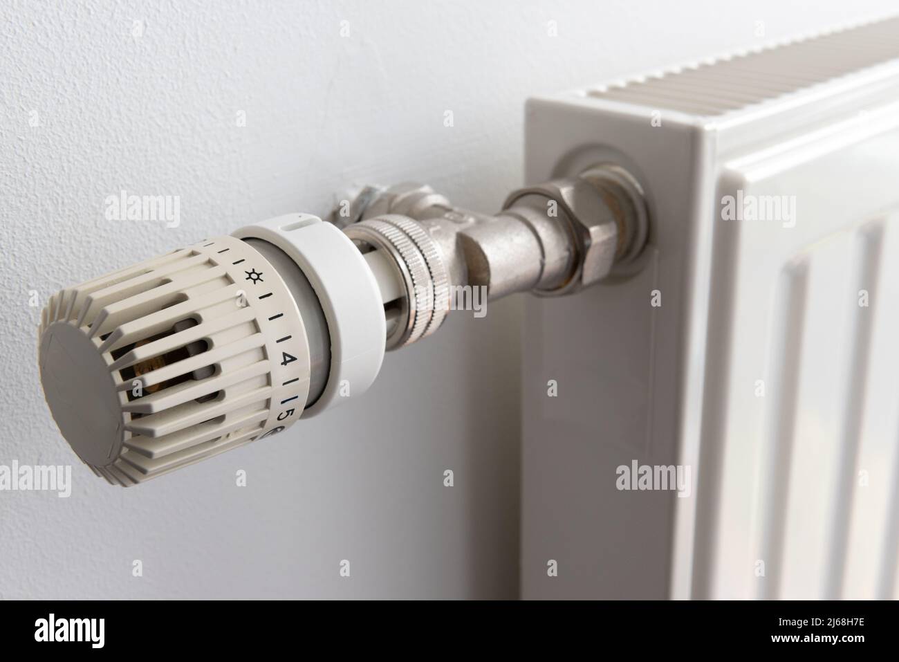Radiator thermostat on blue background Stock Photo - Alamy