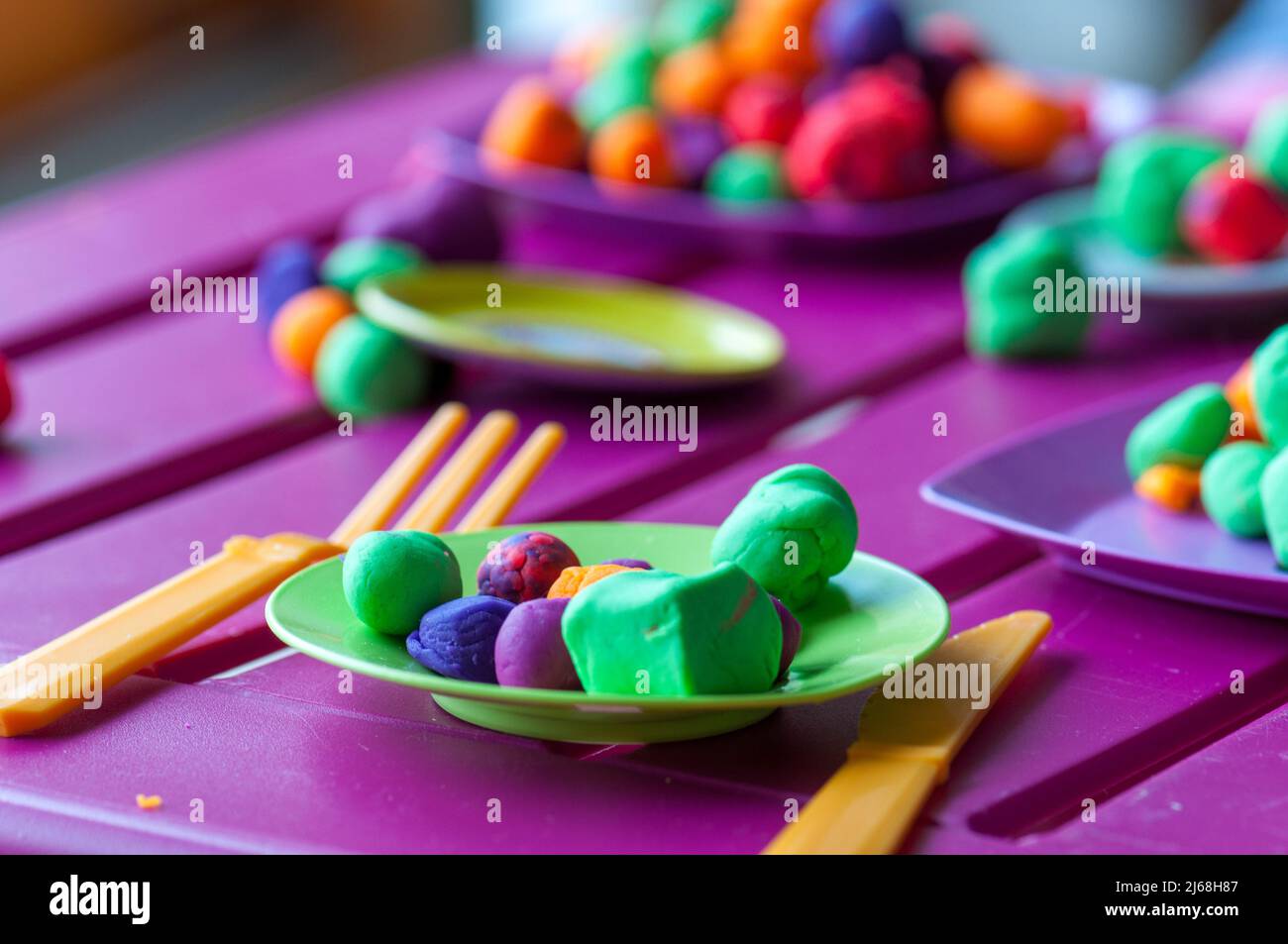 little girl playing with modeling clay Stock Photo - Alamy