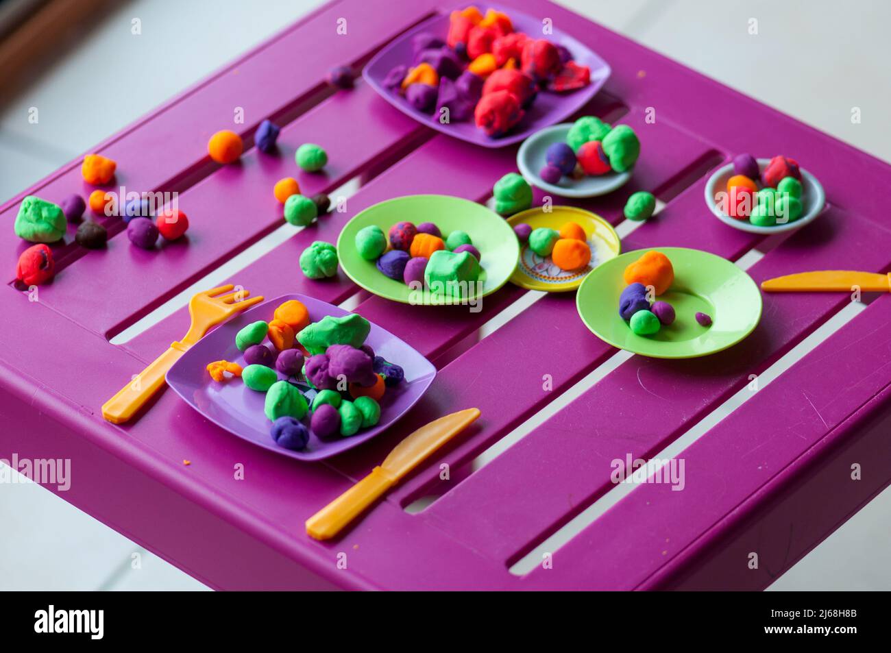 little girl playing with modeling clay Stock Photo - Alamy