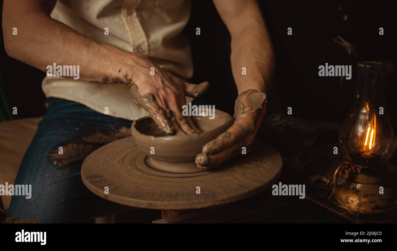 man makes Plate in pottery workshop, clay product, authentic atmosphere ...