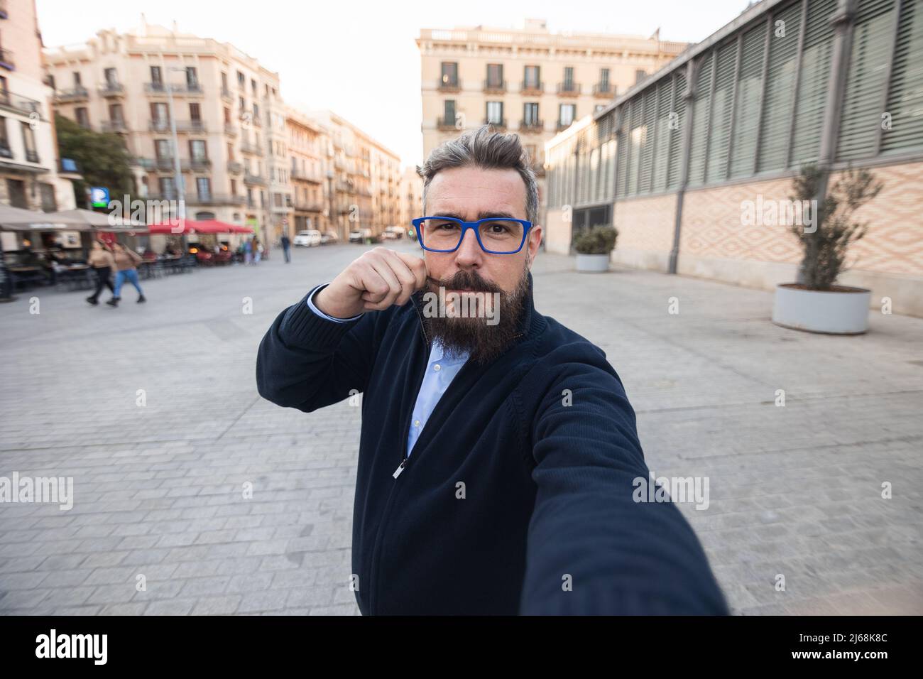 Touching his mustache hi-res stock photography and images - Alamy