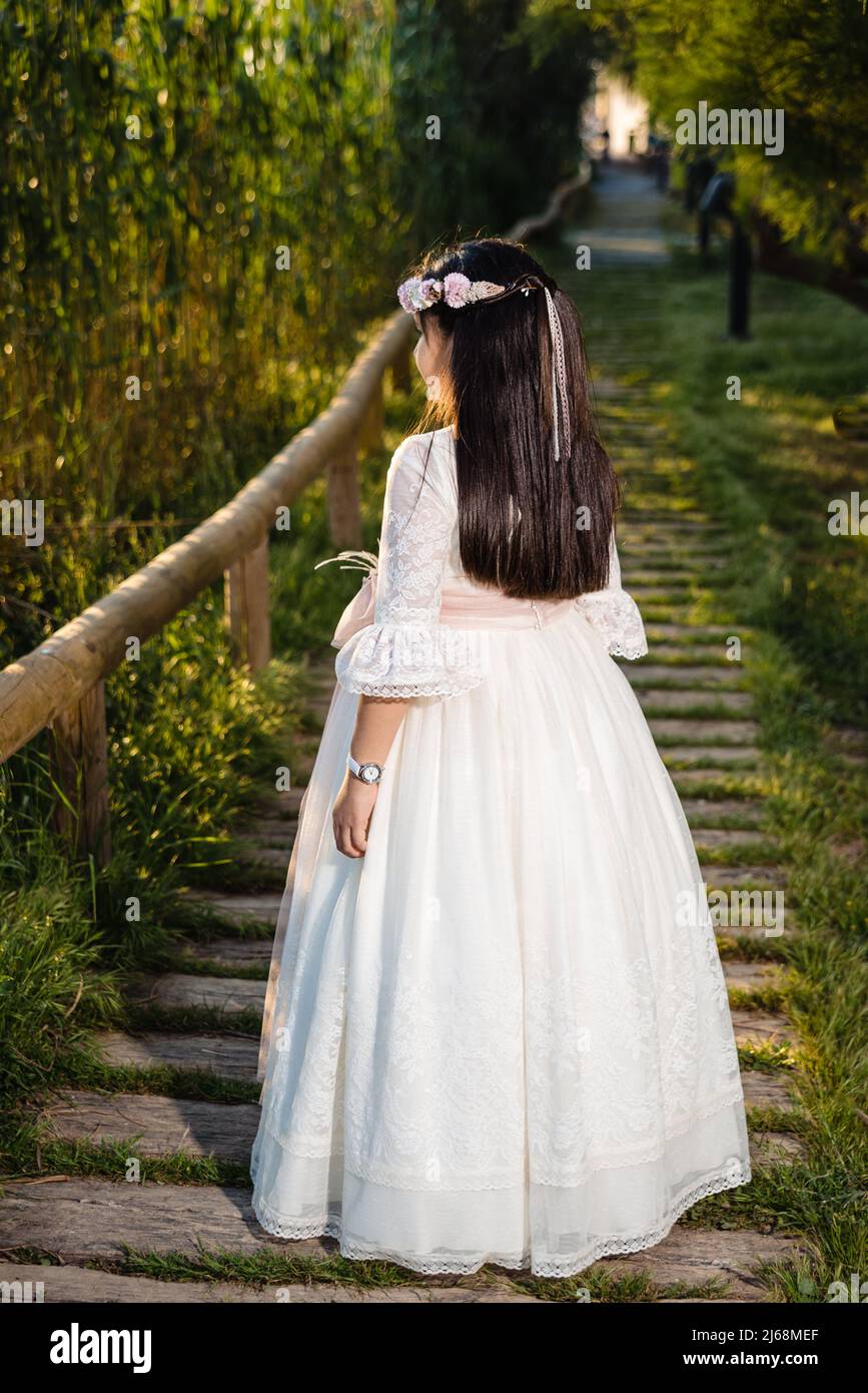 Girl with the white communion or Latin quinceañero dress, with her back ...