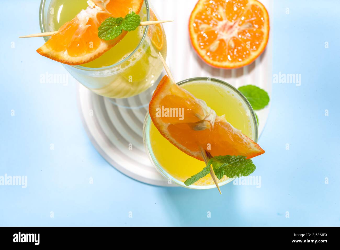 Classic summer mimosas cocktail, with orange juice, on light blue ...