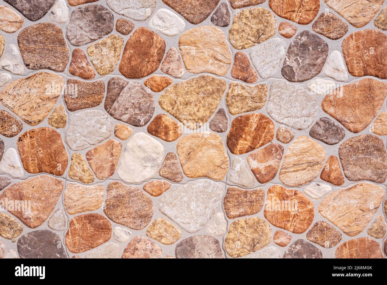 Textured background of a decorative shiny smooth polished rock wall for ...