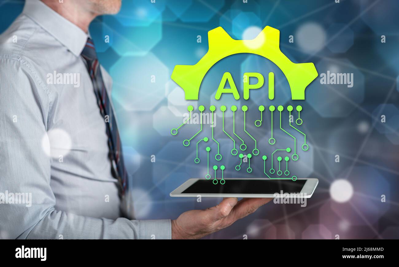 Api concept above a tablet held by a man Stock Photo - Alamy