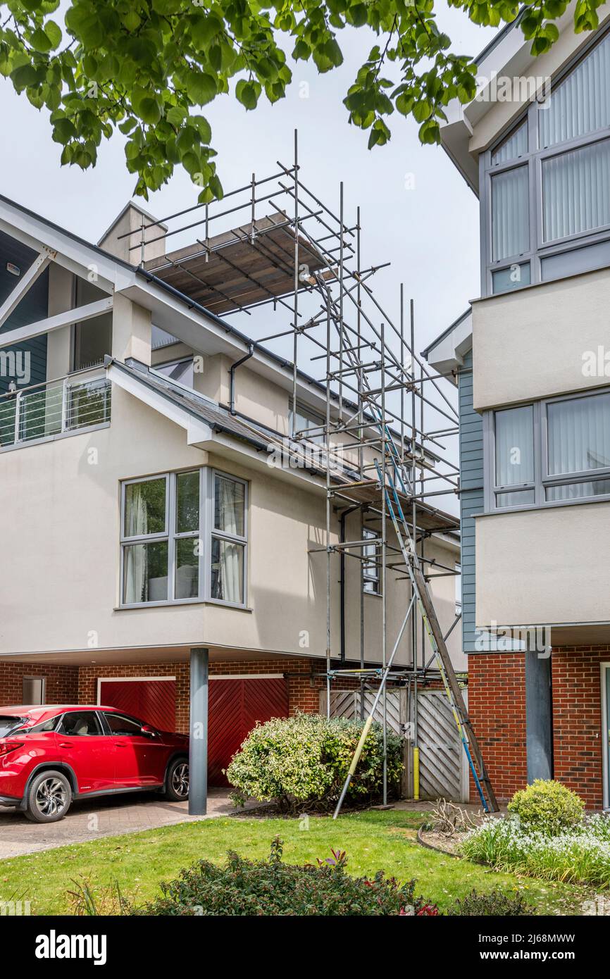 Scaffolding on a modern town house to repair storm damage to the roof ...