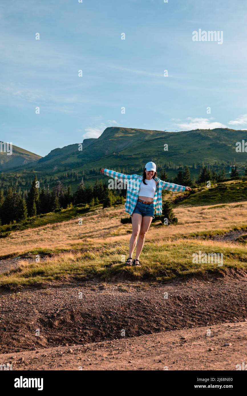 woman enjoying sunset above the mountains hiking concept Stock Photo ...