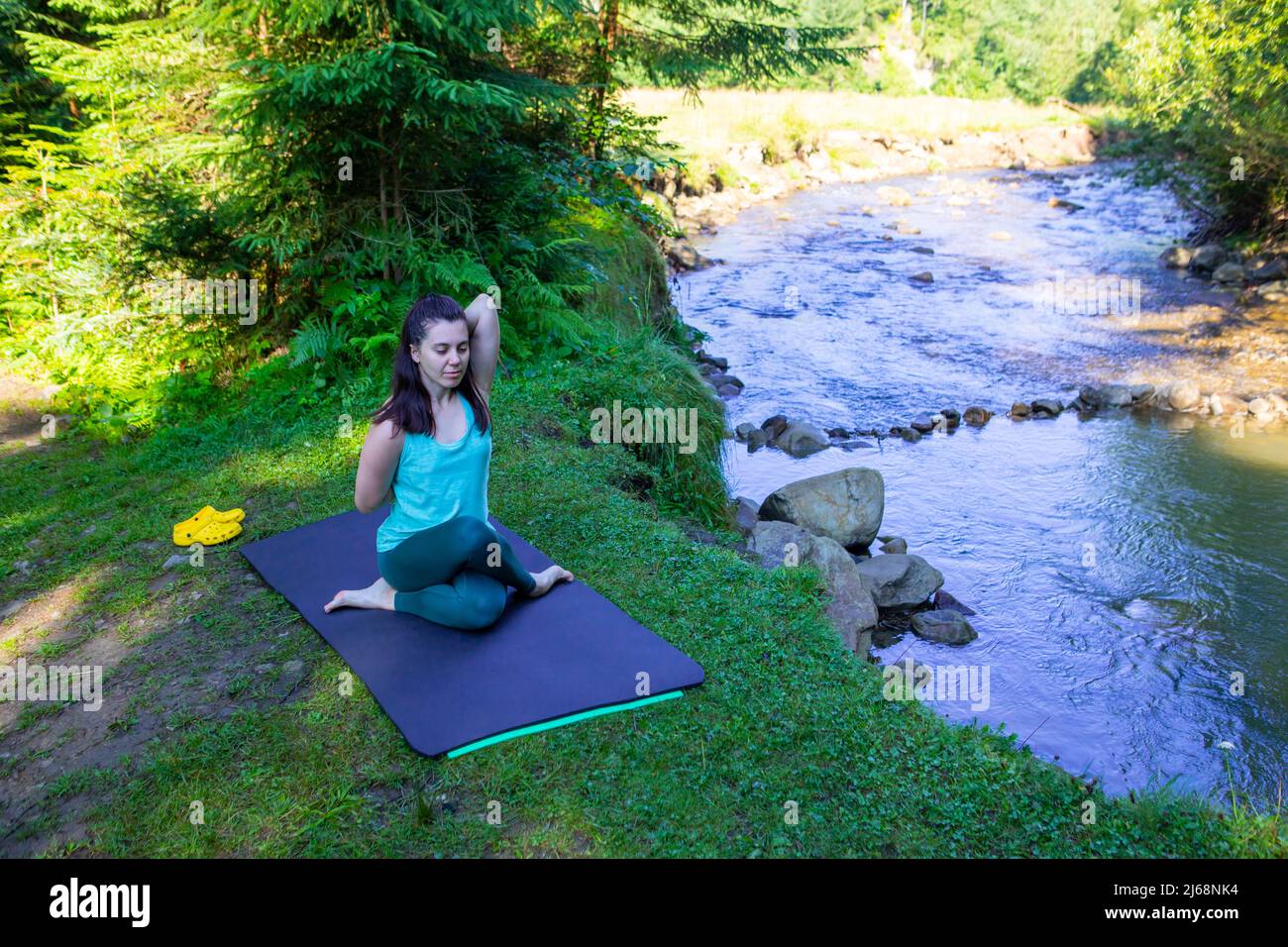 Woman yoga mountains river beach hi-res stock photography and images ...