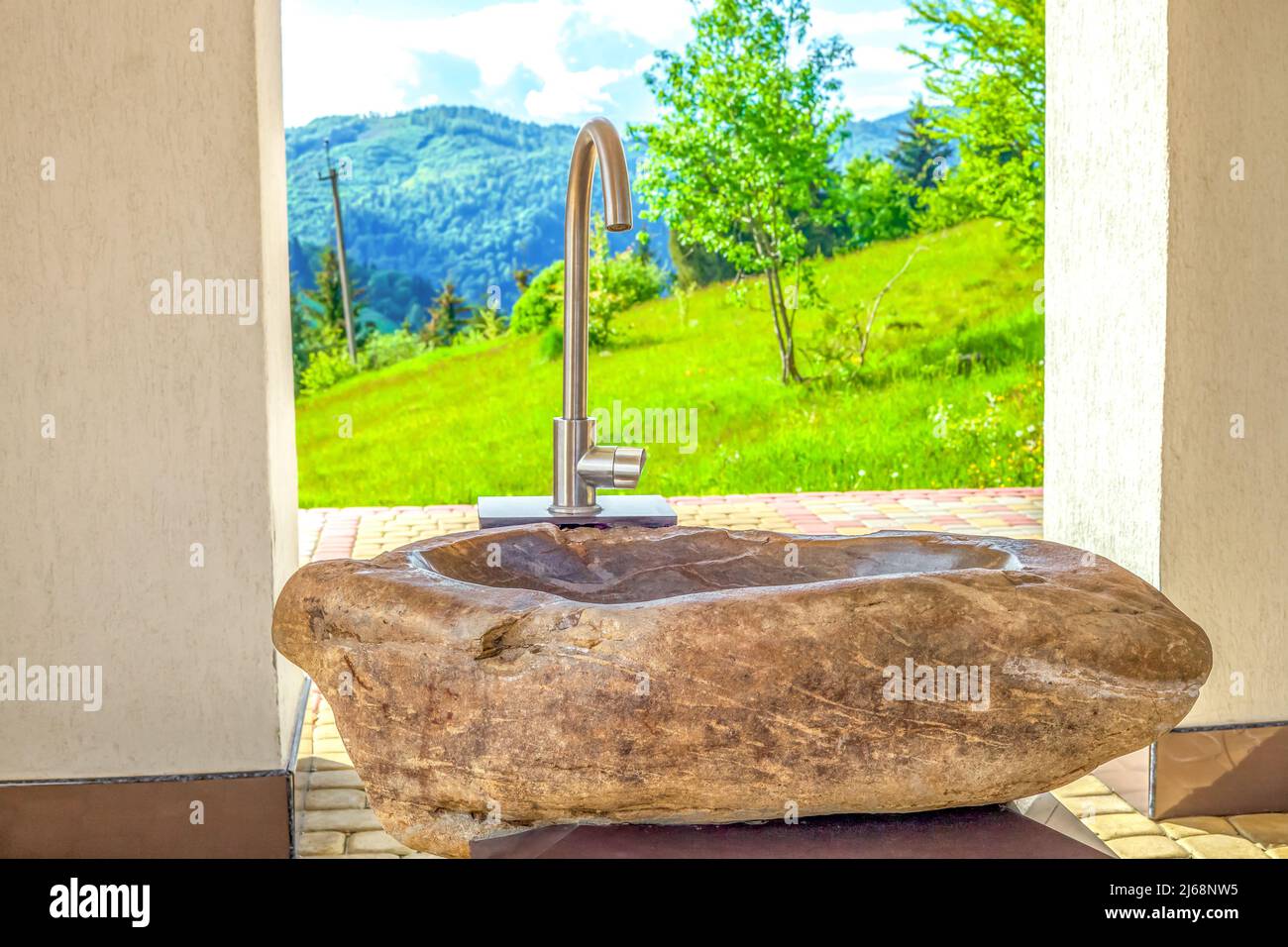 Stone washbasin in spring sunlight yard. Modern sink in summer backyard ...