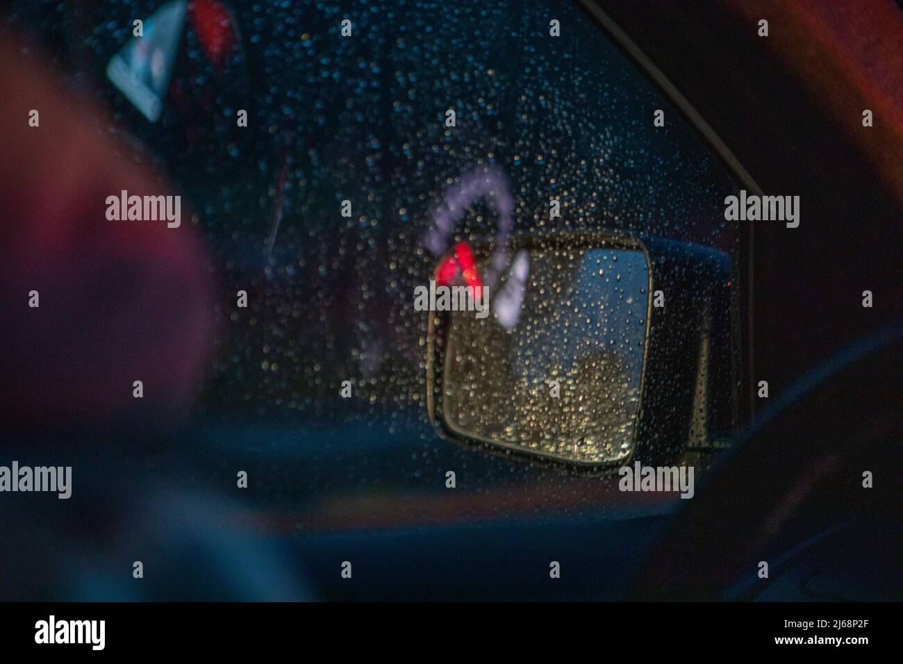 night car driving rain drops on window side mirror Stock Photo - Alamy