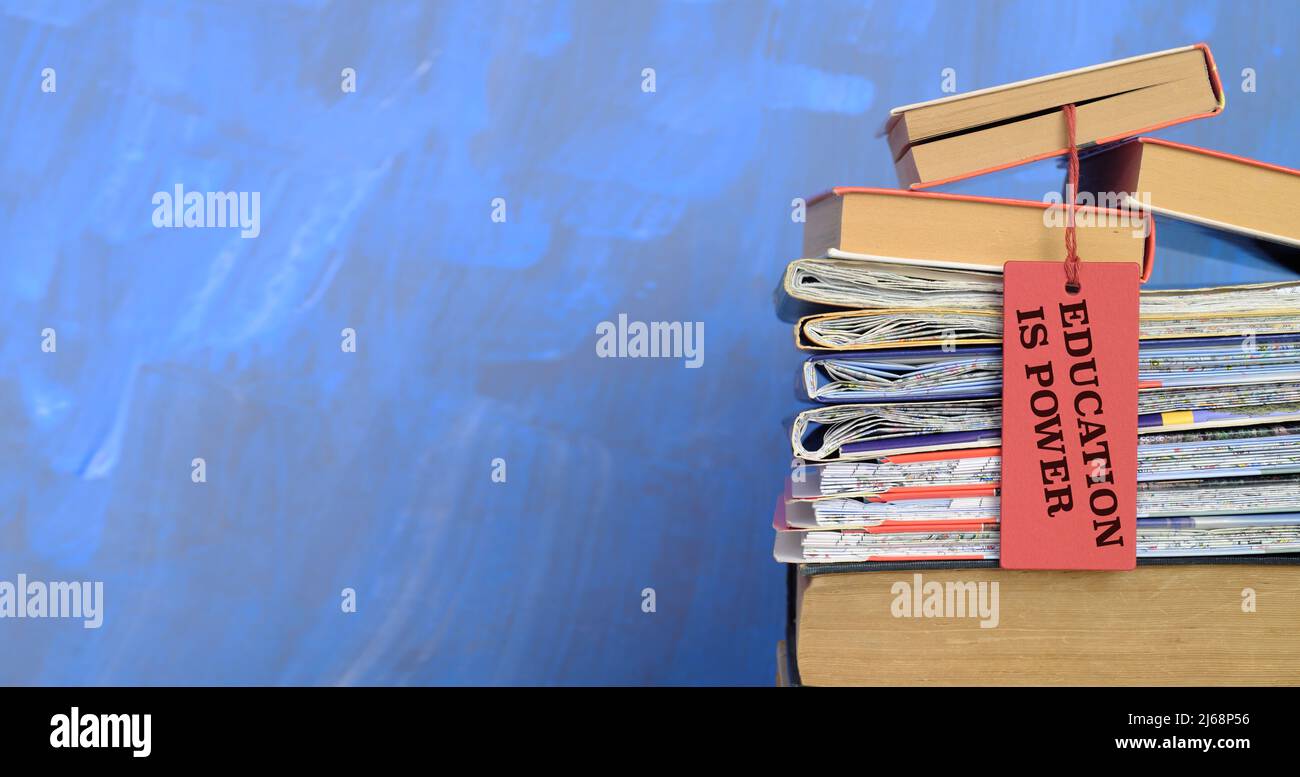 stack of books, folded maps and slogan knowledge is power,learning ...