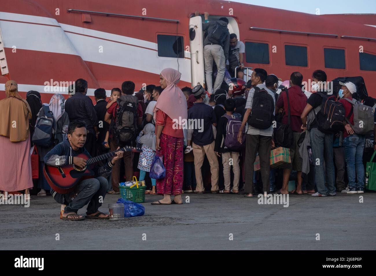 A blind person seen singing among the crowded queues of passengers ...