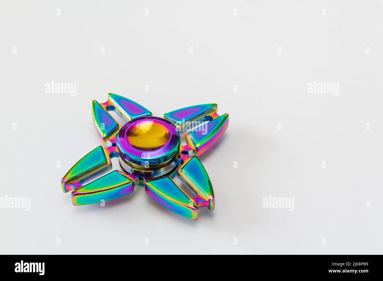 Star shaped stainless steel metalic fidget spinner on white background ...