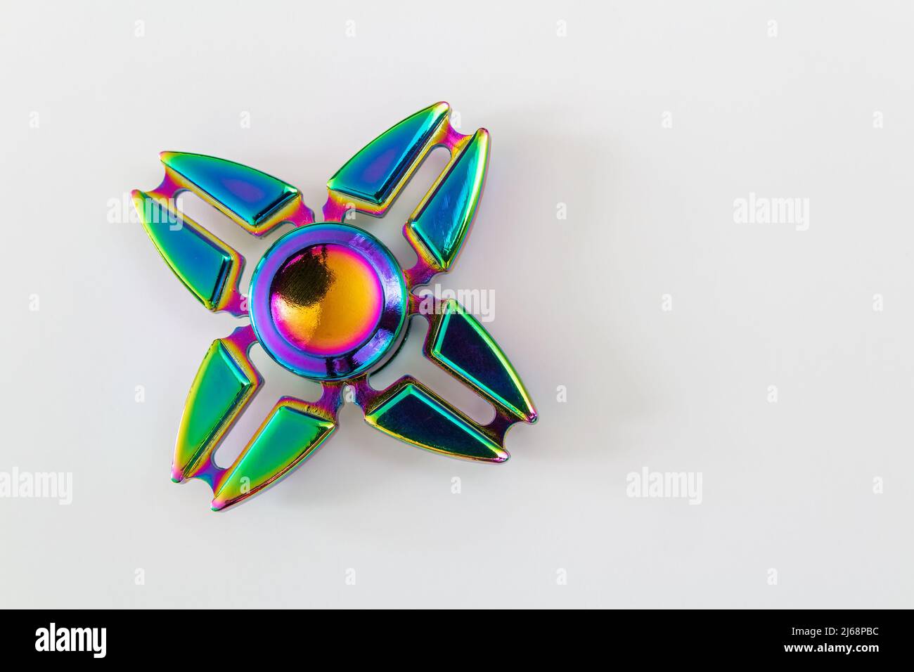 Top view on star shaped stainless steel metalic fidget spinner on white ...