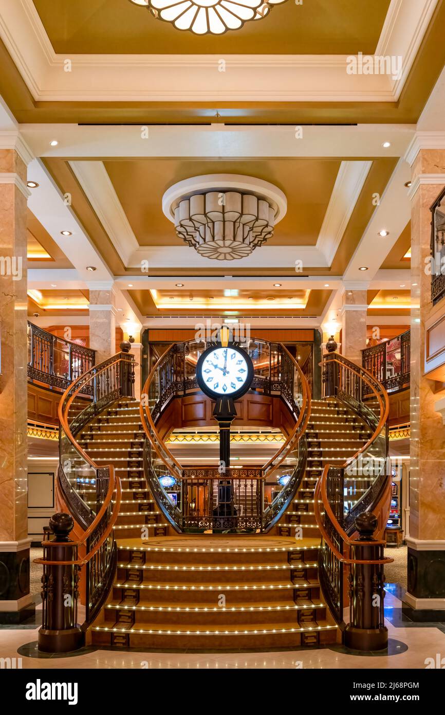 A large clock over one of many staircases linking decks inside the ...