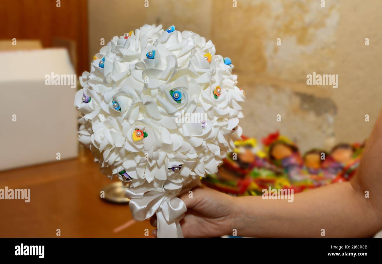 Bouquet of white and colored fabric flowers with pins that the bride ...