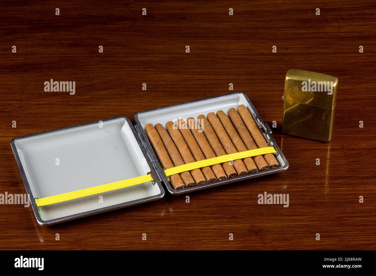 Small cigars in cigar case on old varnished wooden surface with old ...