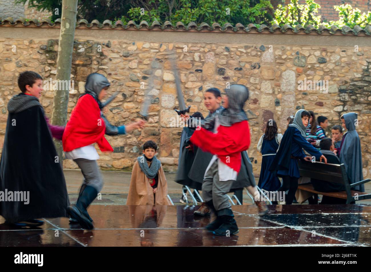 the medieval fair of Montblanc, with children playing as ancient ...