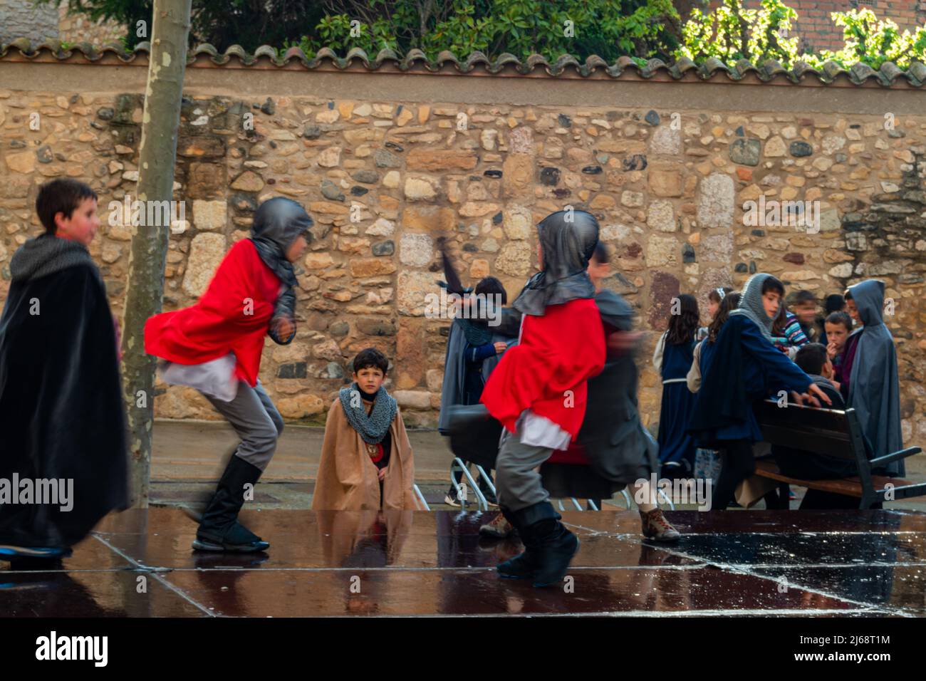 the medieval fair of Montblanc, with children playing as ancient ...