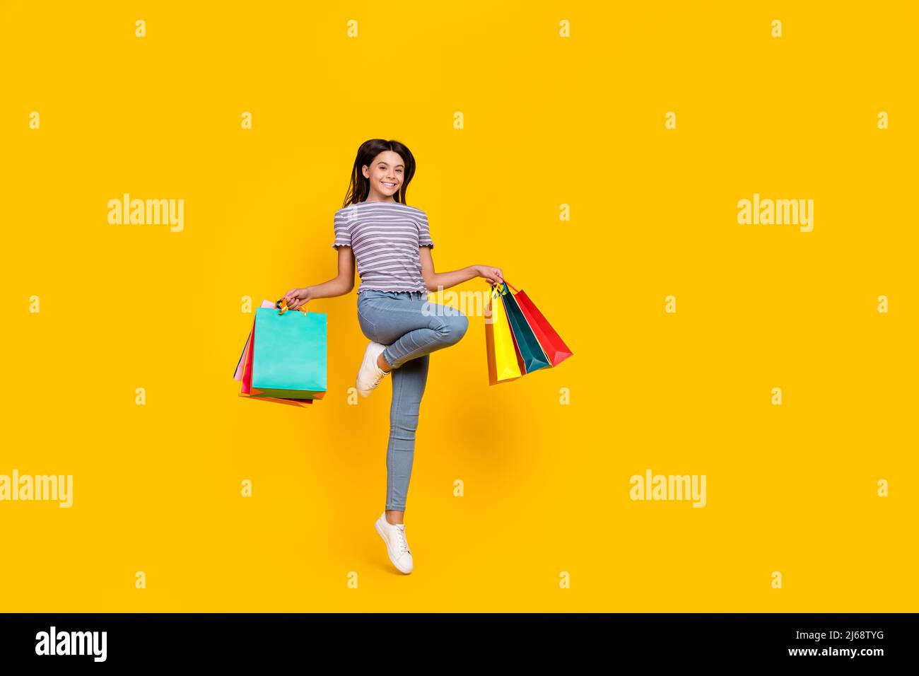 Full length photo of young girl jump shopping store holiday present ...