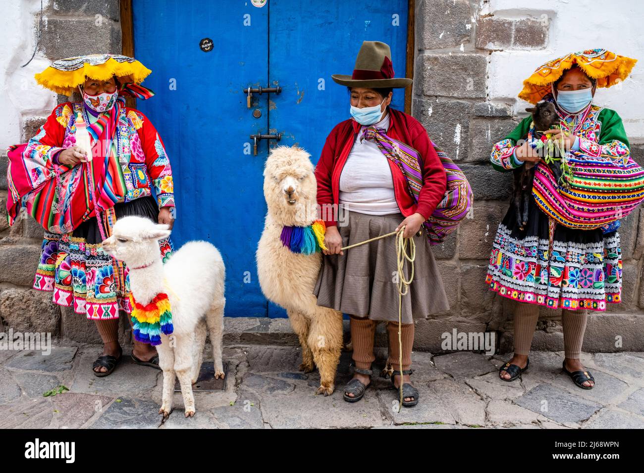 Women In Traditional Costume Pose With Their Pet Alpacas in The San ...