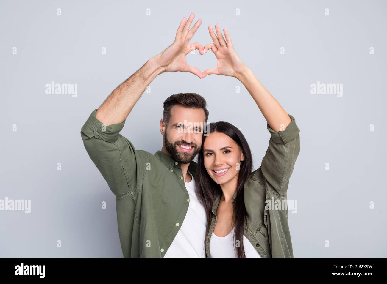 Portrait of attractive sweet gentle cheerful couple hugging showing ...