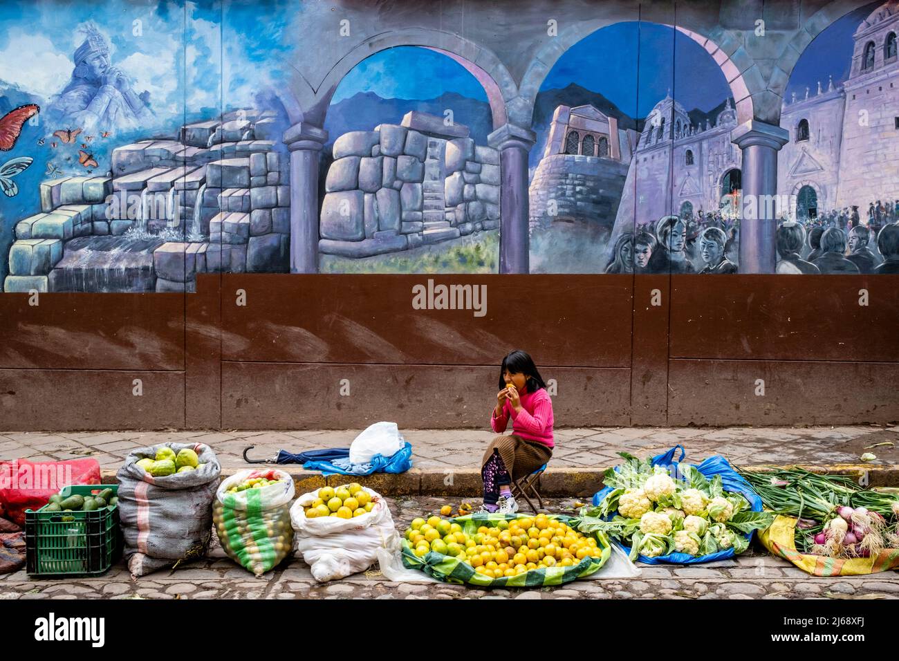 A Child Selling Fruit and Vegetables Eats Lunch At An Outdoor Fruit and ...