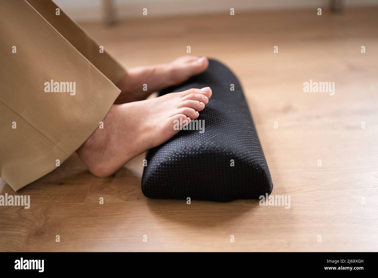 Worker Using Footrest To Reduce Back Strain And Feet Fatigue Stock ...