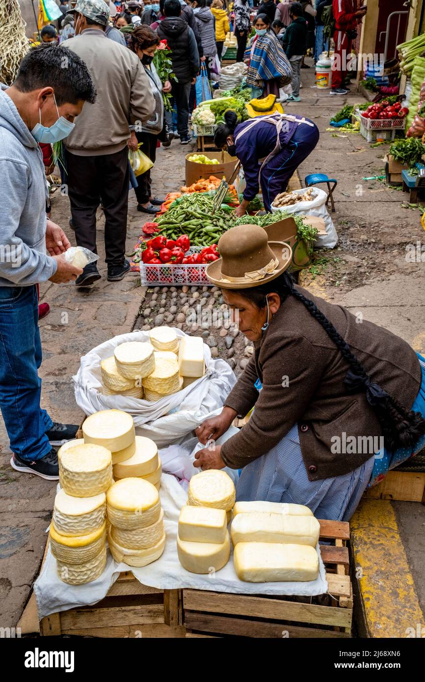 An Indigenous Woman Selling Fresh Cheese At A Street Market In Cusco ...