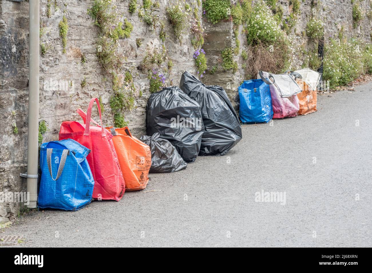 Pile of weekly domestic rubbish outside rural house awaiting refuse ...