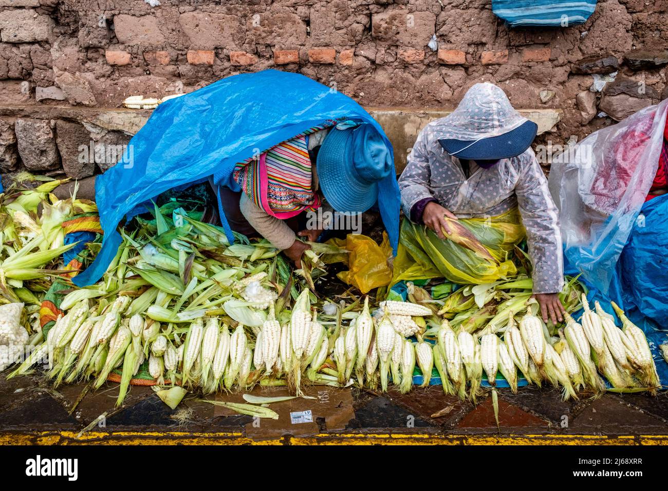 Local Women Selling Choclo (Corn) In The Rain At An Outdoor Street ...