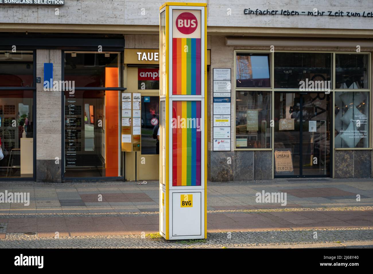 Bus stop of the BVG in Berlin colored with the rainbow flag to support ...