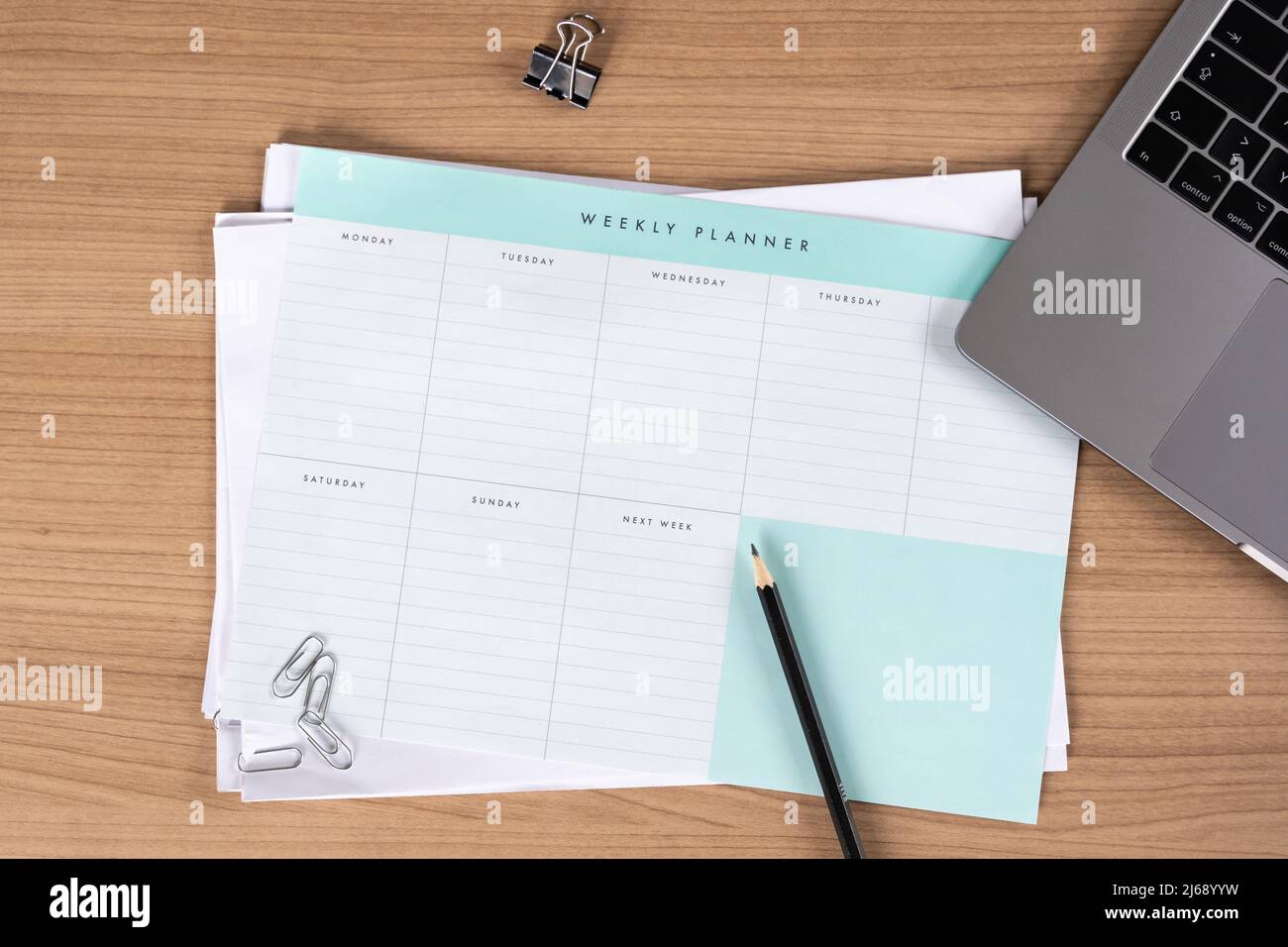 Blank weekly planner notice block on a desk in an office. Empty ...