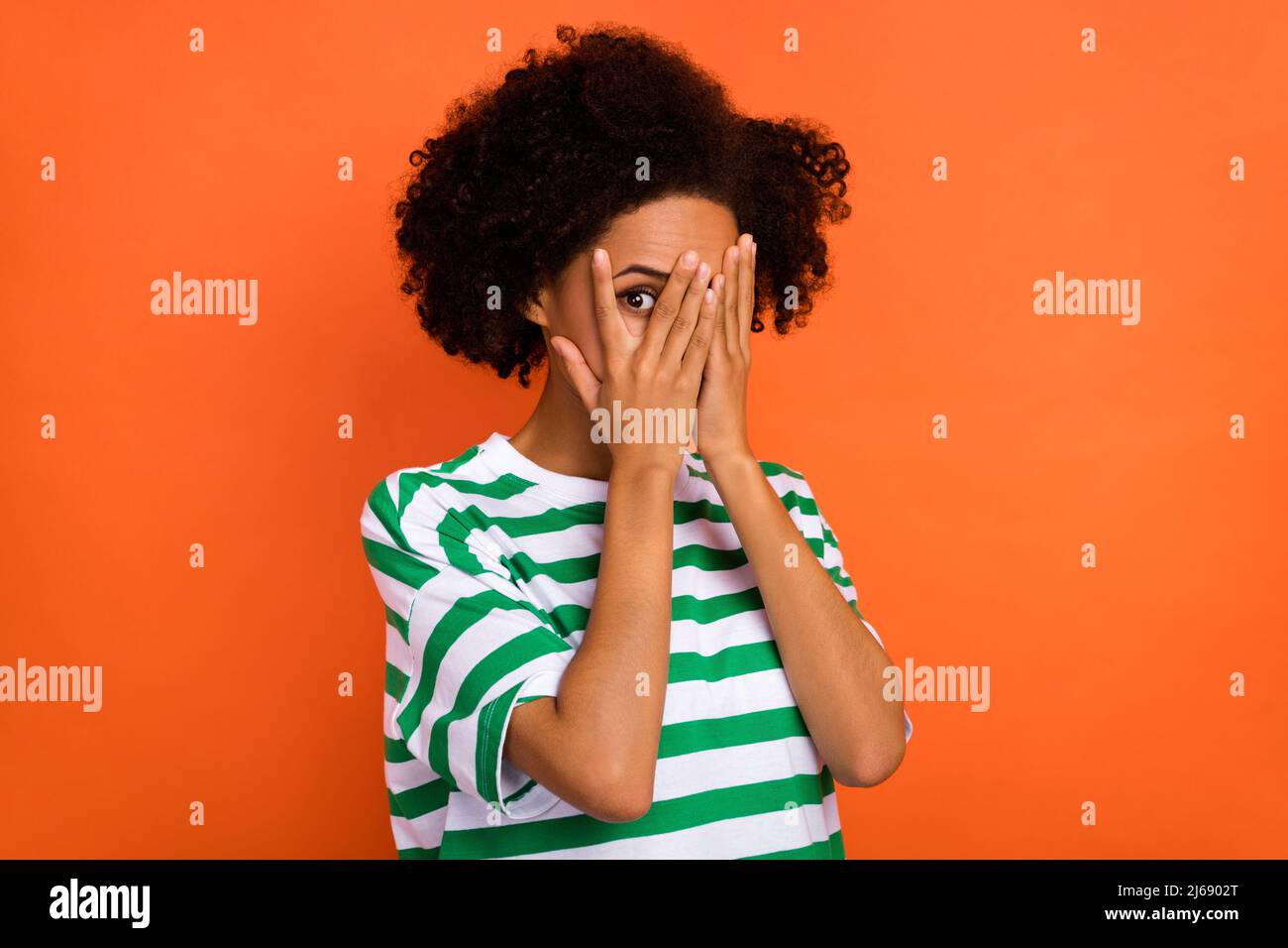Portrait of attractive funny scared brunette wavy-haired girl hiding ...