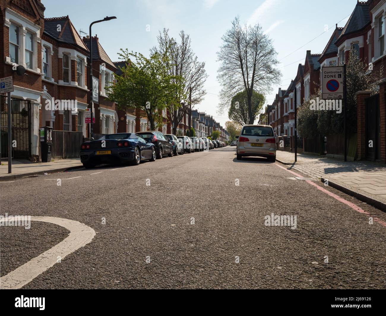 Street view of a residential district with a lot of red houses ...